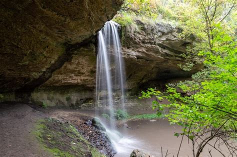 Premium Photo Waterfall Flows Over Two Huge Rocks
