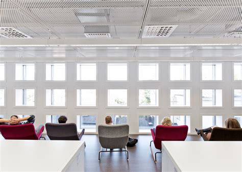 Curving Voids Pierce The Floors Of Anttinen Oivas Helsinki Library