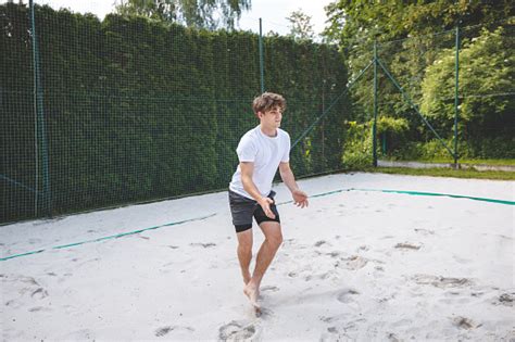 모래 코트에서 배구를 받거나 파낼 준비를 하는 준비된 위치에 있는 젊은이 야외 환경에서 비치 발리볼의 강렬함과 집중력을 포착하기 25 29세에 대한 스톡 사진 및 기타