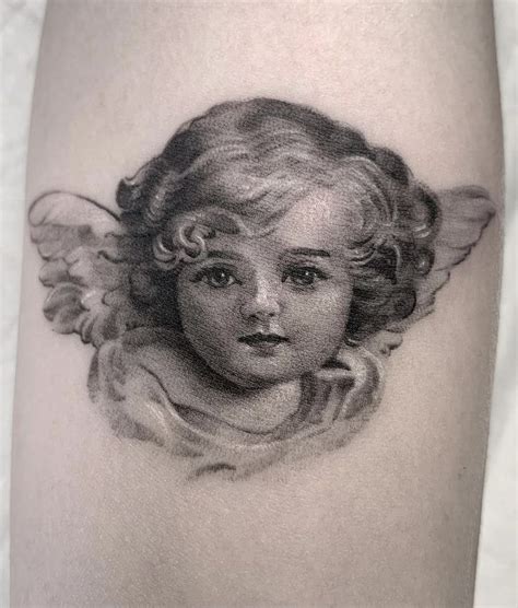 Angel Face With Wings Tattoo