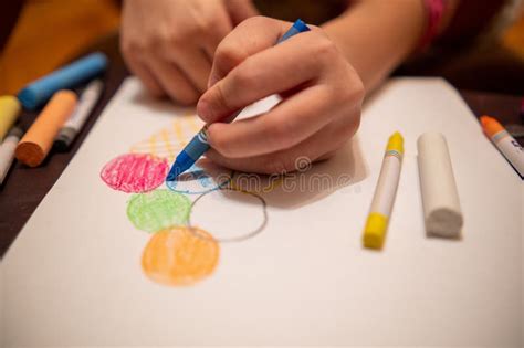 draw with colored pencils on a white sheet of paper stock image