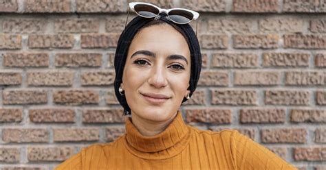 검은 머리 스카프를 두르고 웃으며 카메라를 바라보는 예쁜 젊은 무슬림 여성 사진 Unsplash의 스페인 이미지