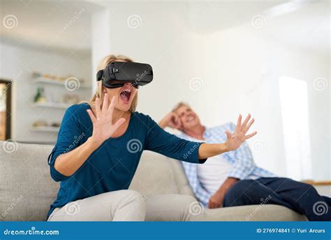 Exploring The Cyber World A Mature Woman Wearing A Vr Headset With Her