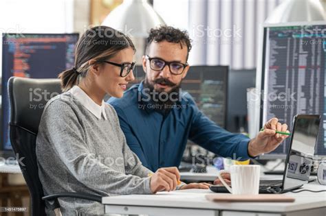 software programmers analyzing html code and database brainstorming