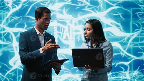 Coworkers Solving Tasks On Laptop And Tablet Running Artificial
