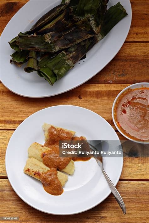 Grilled Otakotak Wrapped In Banana Leaf Poured With Peanut Sauce Stock