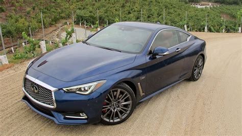 Download Sleek Infiniti Q60 Sports Coupe In Scenic Road Trip Wallpaper