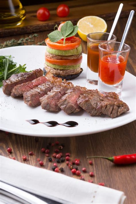 Juicy Freshly Grilled Steak Served With Chili Sauce And Vegetables