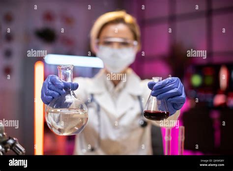 Female Scientist Testing Experiment In A Science Lab Where She Holding Scientific Test Tube Full