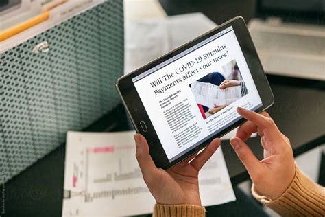 Taxes Woman Reading About Stimulus And Tax Filing By Stocksy Contributor Sean Locke Stocksy
