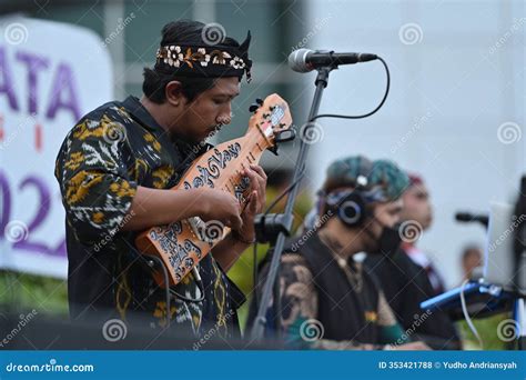 Musician Playing Traditional Sape Instrument At A Cultural Event