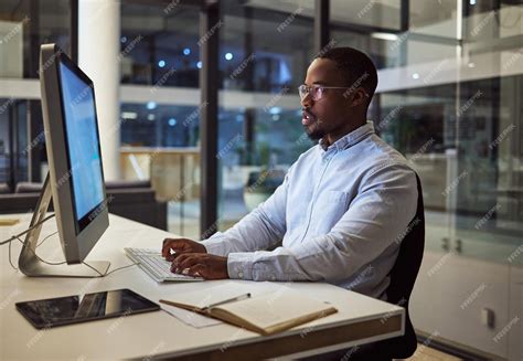 Premium Photo Businessman Typing On Computer With Internet Analytics In An Office At Night