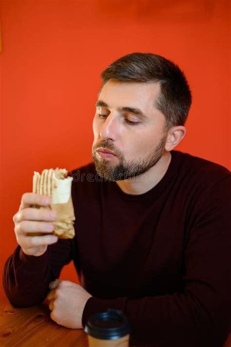 A Man With A Beard Eats Shawarma A Quick Tasty And Healthy Snack At A