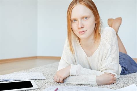 Free Photo Redhead Woman Lying On Floor With Notebook And Tablet