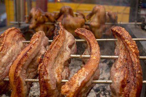 Several Pieces Of Liempo Or Pork Belly Skewered On A Spit And Roasted