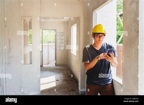 Engineer Or Architect Using Cell Phone In Building Construction Site Stock Photo Alamy