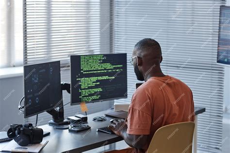 Premium Photo Minimal Back View Of African American Man Writing Code In Green Lines And Using