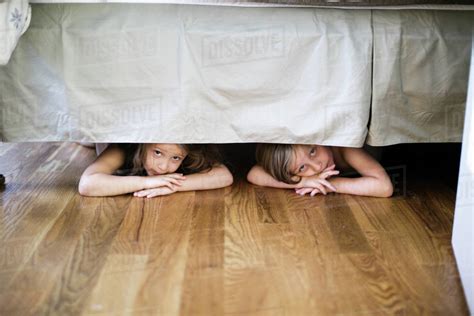 Boy And Girl Hiding Under Bed Royalty Free Stock Photo Dissolve