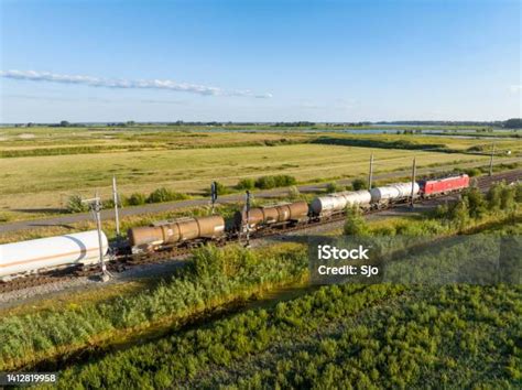 Freight Train Pulling Railroad Cars On A Railroad Track In The