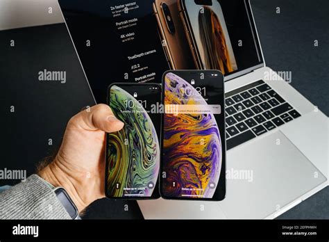 PAris France Sep POV Male Hand Holding Compare Two New Latest Smartphones By Apple