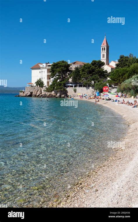View Of Martinica Beach Near Bol On Brac Island In Croatia With People Sunbathing And Swimming