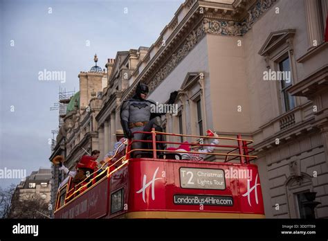 A Character Batman On Top Of London Red Bus Greets Fans During The