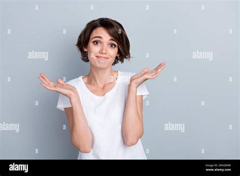 Photo Of Puzzled Clueless Lady Wear White T Shirt Biting Shrugging