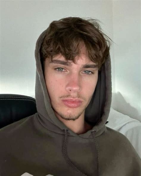 A Young Man Wearing A Hoodie Looking At The Camera