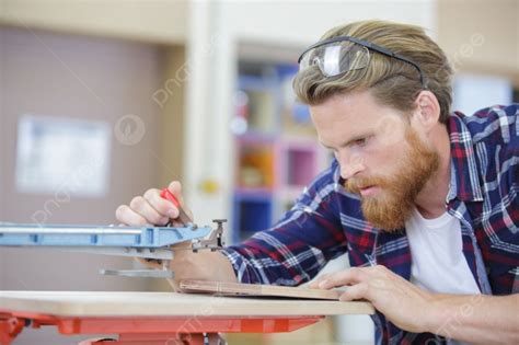 Young Man Is Calibrating Cutting Machine Photo Background And Picture