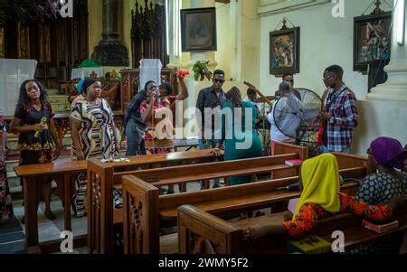 A Band Plays As A Woman And Other Worshippers Sing On Sunday In The
