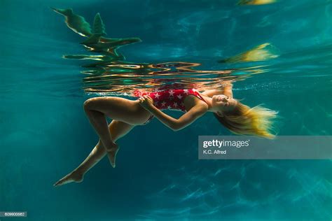A Female Model Underwater In A Star Patterned Swimsuit High Res Stock