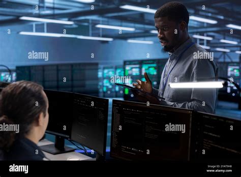African American Man In Data Center Using Diagnostic Tools And System