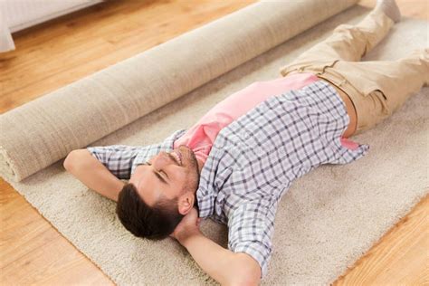 Happy Man Lying Carpet Or Rug At Home People Repair And Renovation