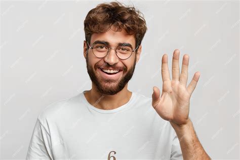 Premium Photo Smiling Young Man With Glasses Greeting Happily Casual