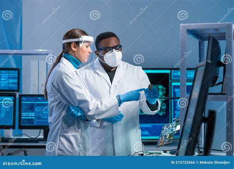 Diverse Team Of Microelectronic Engineers Discuss Current Developments In A Science Lab