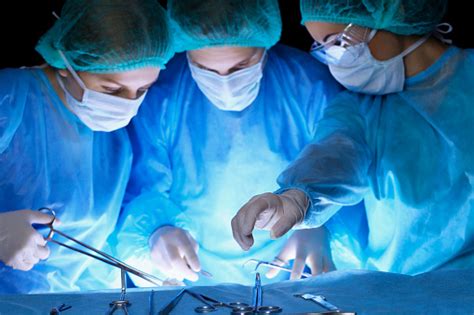 Group Of Surgeons In Masks Performing Operation Medicine Surgery And
