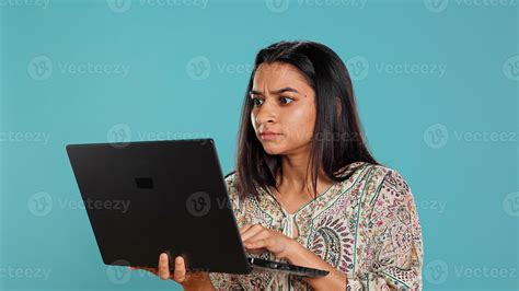 Indian Woman Typing On Laptop Keyboard And Cursing Feeling Angry At Work Person Writing Emails