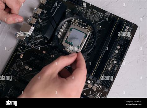 Engineer Plugging Cpu Microprocessor To Motherboard Socket Computer