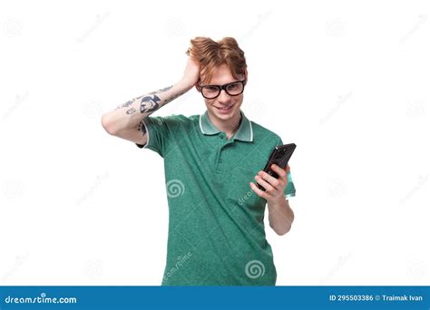A Young European Guy With Red Hair In Glasses Is Trying To Remember The Information Holding The