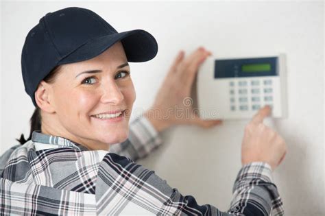 Beautiful Happy Woman Push Button Digital Thermostat At House Stock