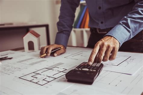Premium Photo Architect Engineer Using Calculator Estimate Construction Drawings With