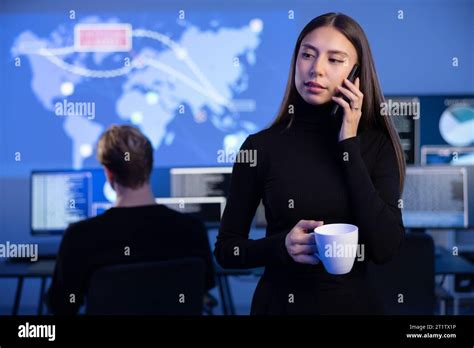 Female Cybersecurity Manager Talking In The Phone In Enterprise Cyber Security Operations Center