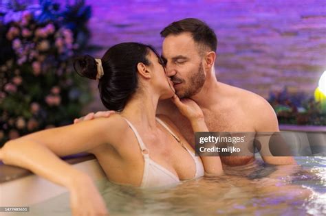 Mid Adult Couple Enjoying Together In Spa Center With Hot Tub High Res