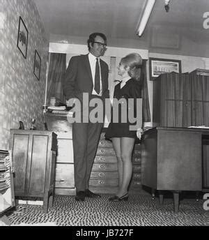 1970s Historical A Secretary Wearing A Mini Skirt Sits On The Edge Of