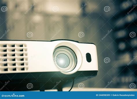 Computer Projector Wih Blue Light Flare Anging In Conference Hall