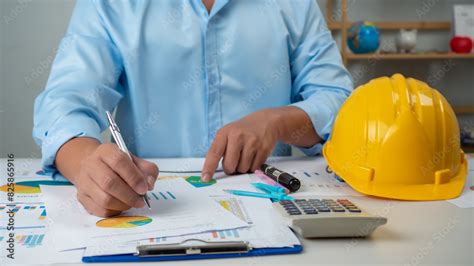 Architect Or Engineer Sitting At Desk In Office Cost Calculation Construction Planning