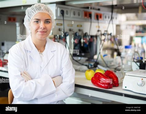 Portrait Of A Positive Female Laboratory Assistant In Uniform In Biochemical Laboratory Stock