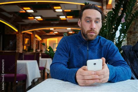 Funny Surprised Adult Man Looking Something In Mobile With Surprised Happy Face Stock Photo