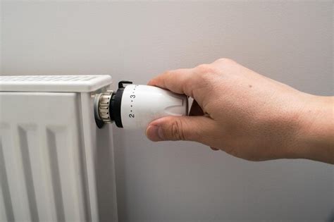 Premium Photo Person Adjusting Thermostat Control On A Central Heating Temperature Control