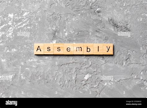 Assembly Word Written On Wood Block Assembly Text On Cement Table For
